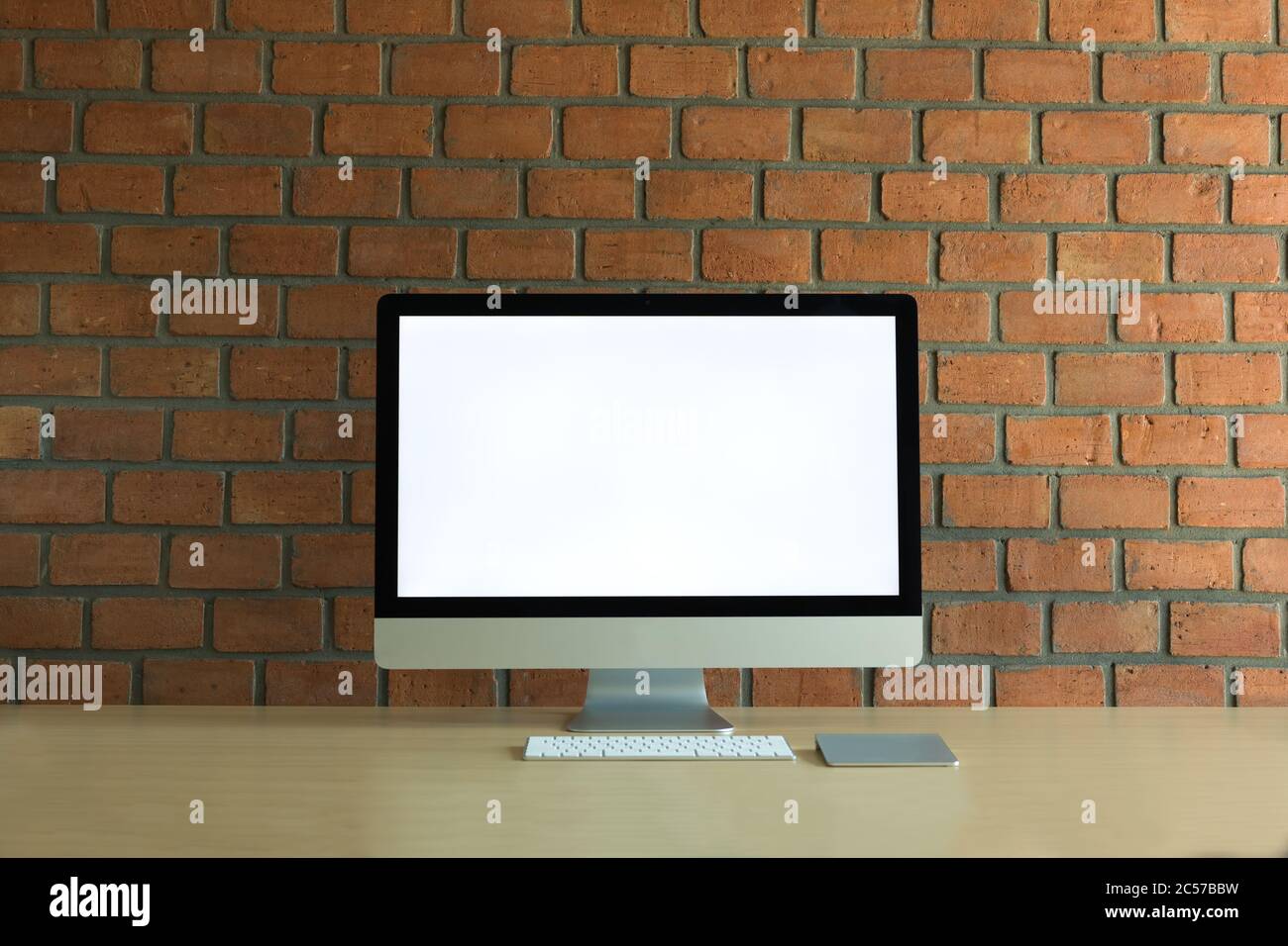 Computer white blank screen on work table Stock Photo - Alamy
