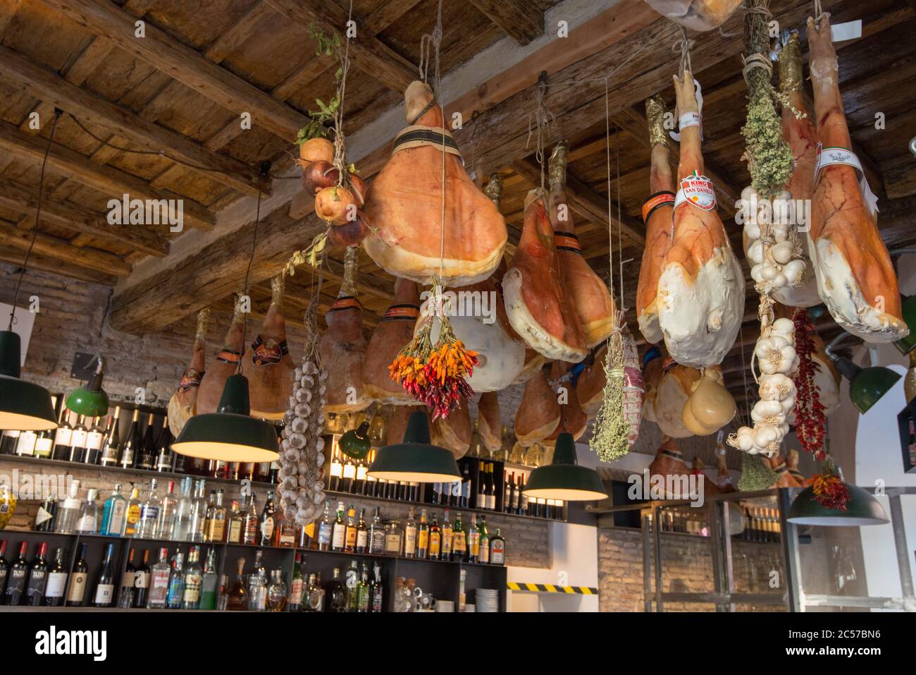 Interior design of a traditional wooden Italian deli with hanging meats ...