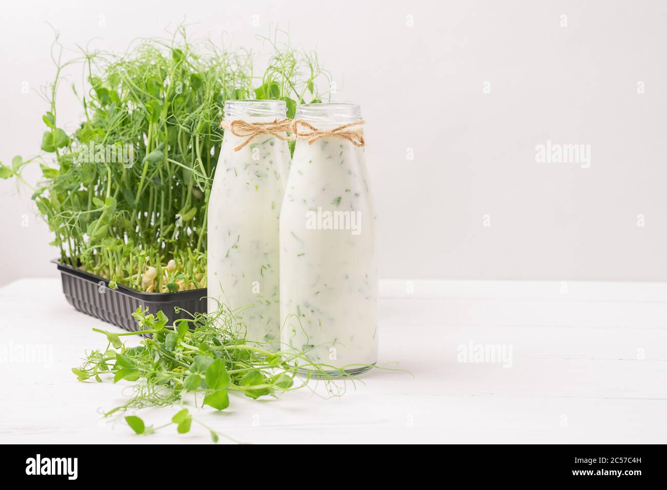 Green smoothie milkshake with the addition of fresh microgreen grass ...