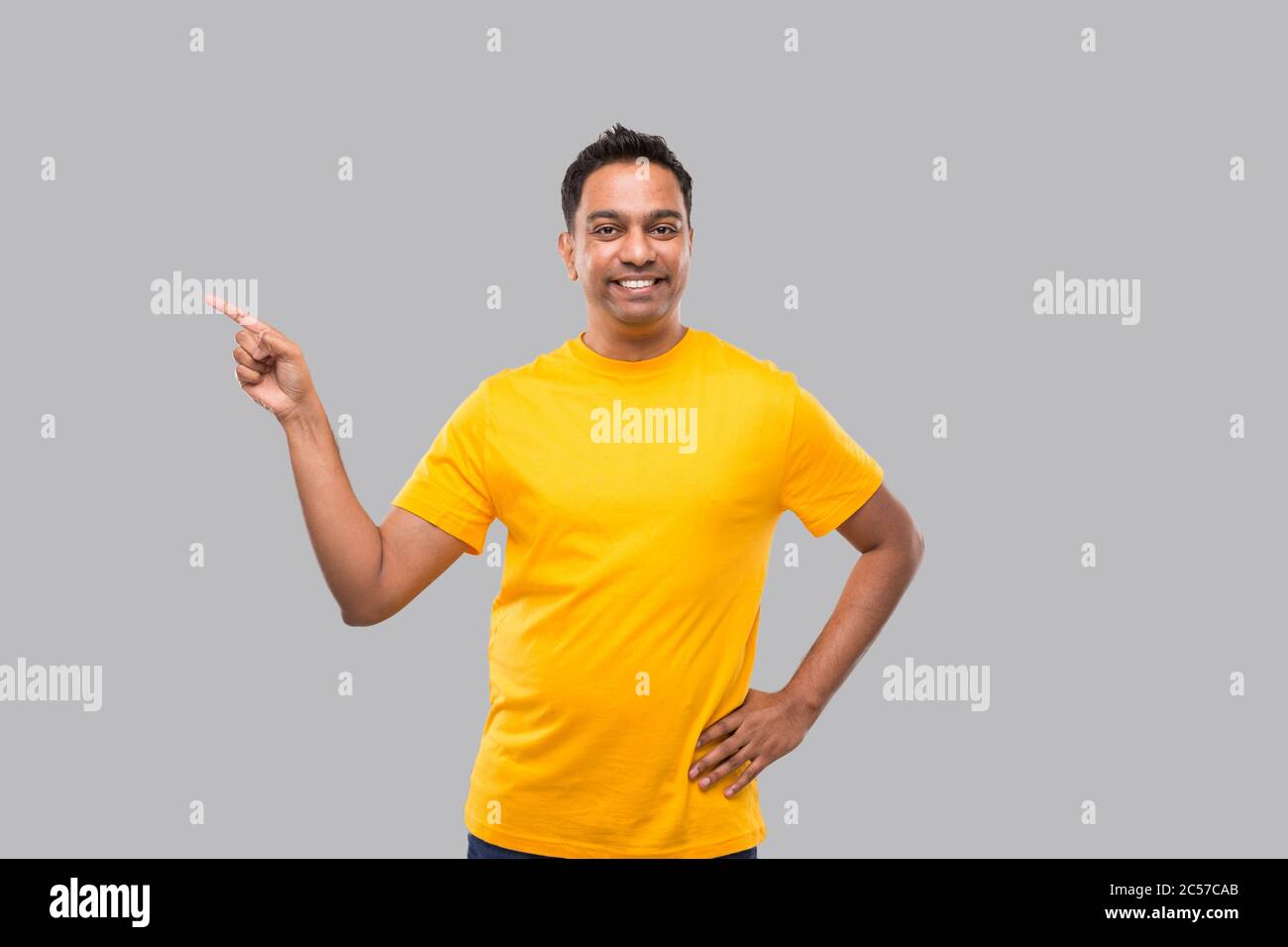 Indian Man Pointing to Side Smilling Isolated Stock Photo - Alamy