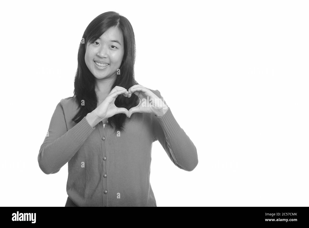 Young happy Asian woman giving heart sign Stock Photo - Alamy