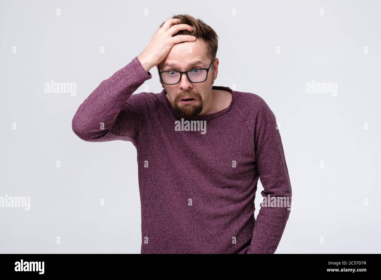 man in terror and shock, holding head, shocked by the quantity his of ...