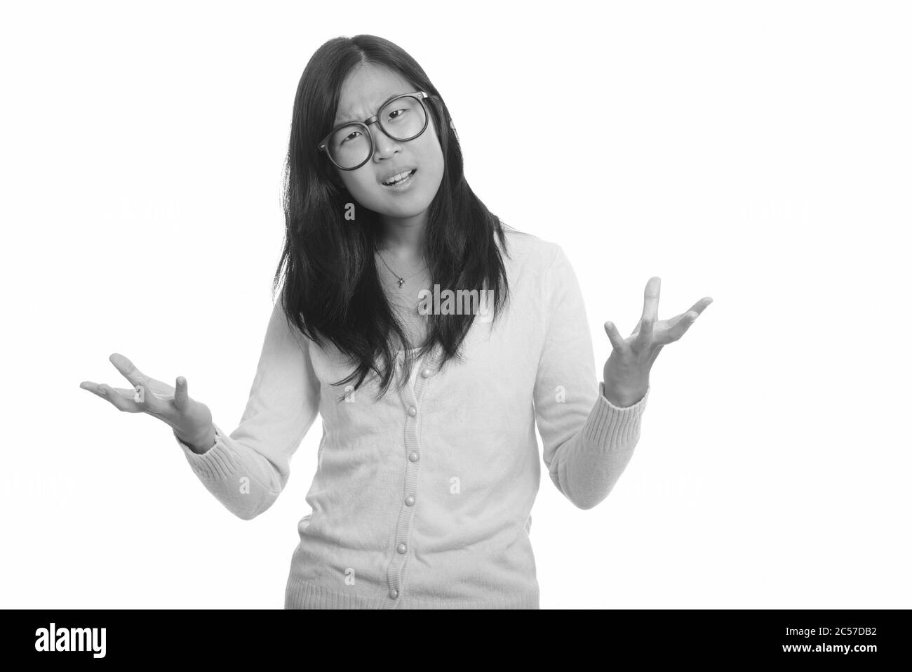 Portrait of stressed young Asian nerd woman looking angry with arms ...