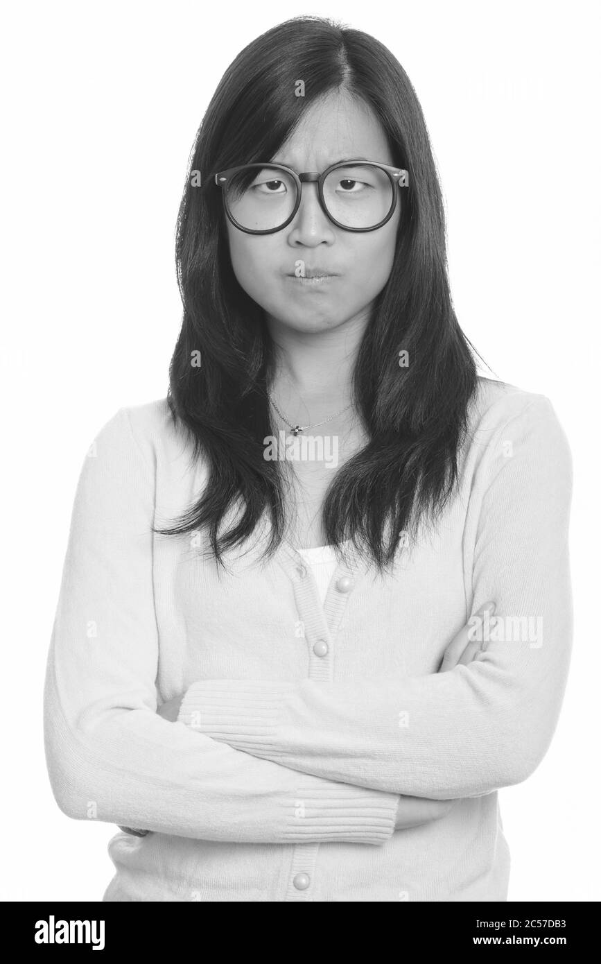 Portrait of stressed young Asian nerd woman looking angry with arms ...