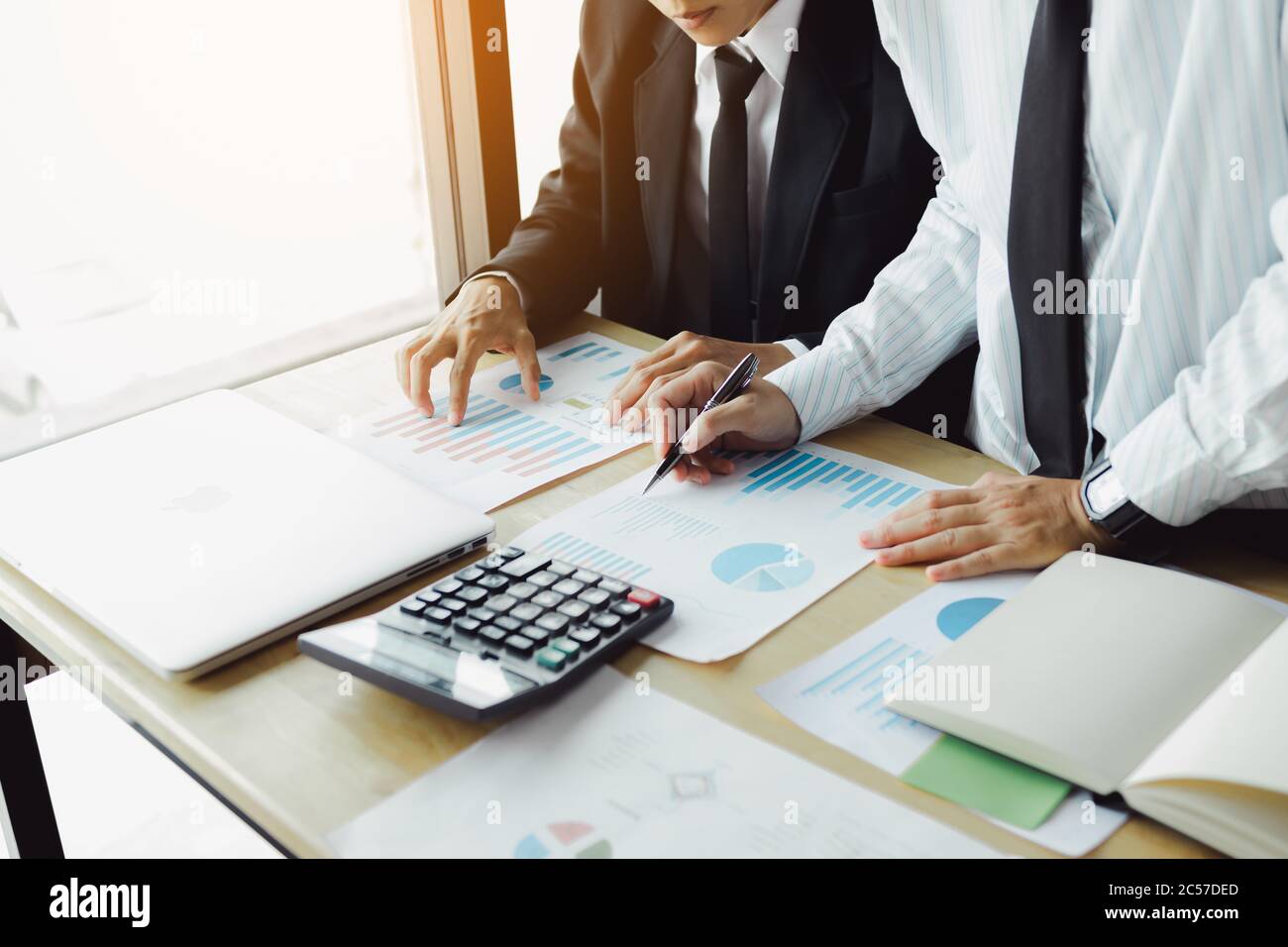 Business people discussion about summary report graph and calculation ...