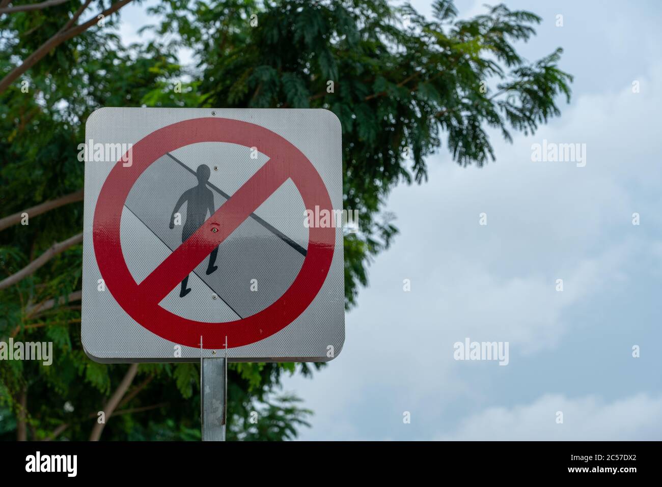Road sign prohibiting pedestrians to cross the road Stock Photo - Alamy