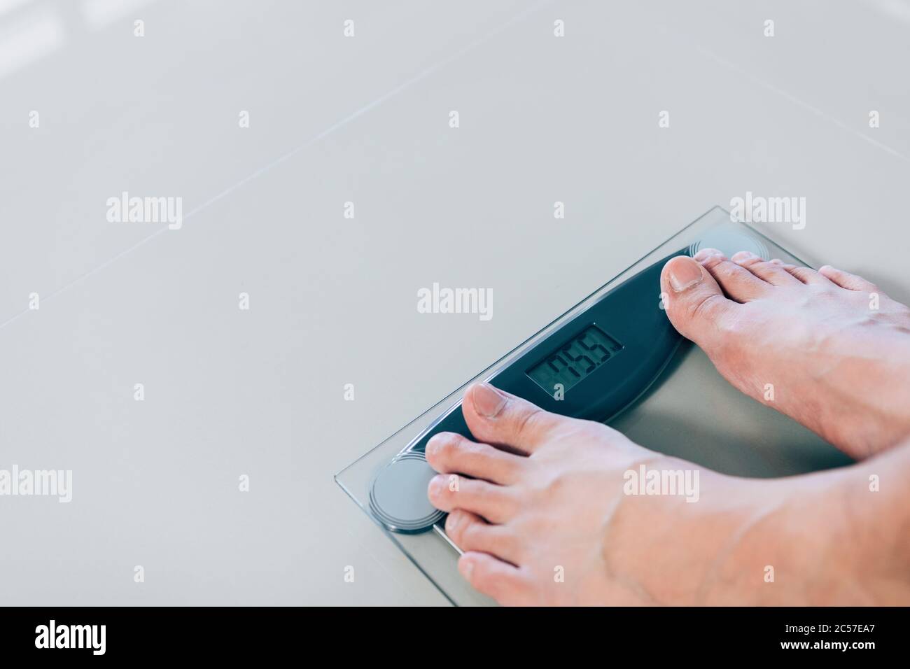 Close up of people feet standing on scale weighing Stock Photo - Alamy