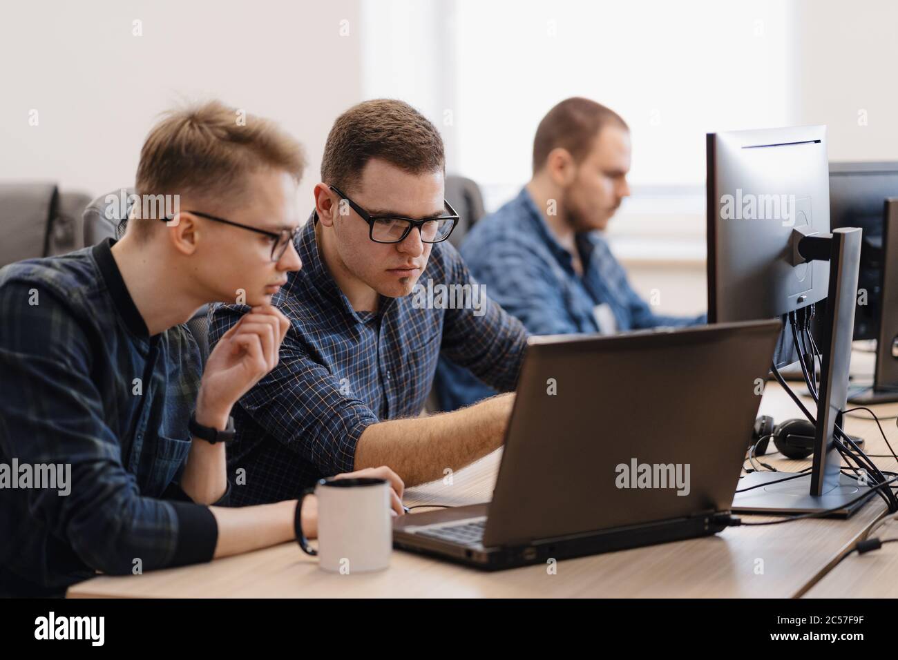 Full concentration at work. Group of young business people working and ...