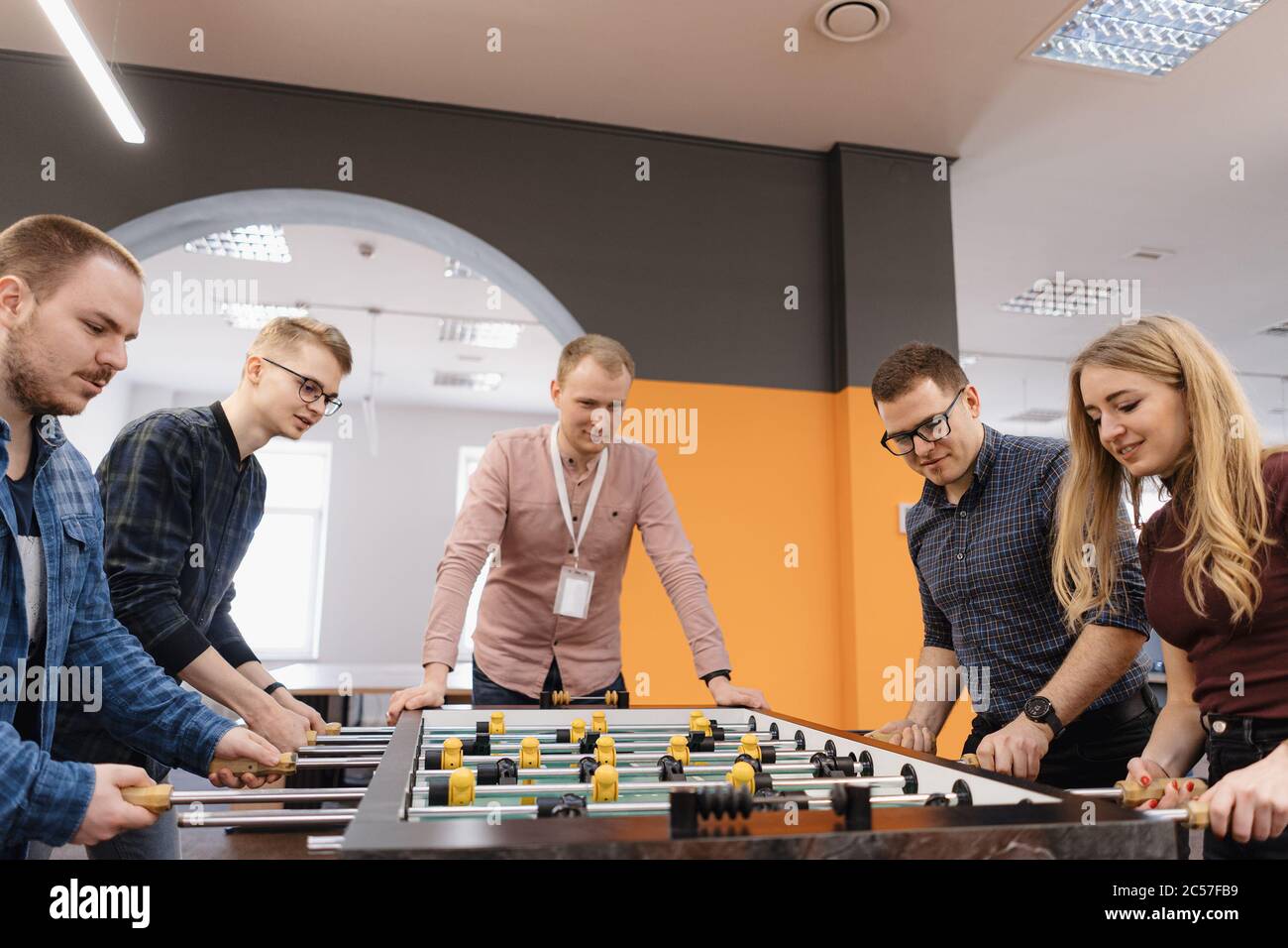 Group of Young Office Workers Playing Table Soccer Game Inside the ...