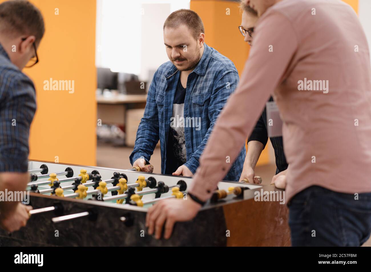 Group of Young Office Workers Playing Table Soccer Game Inside the ...