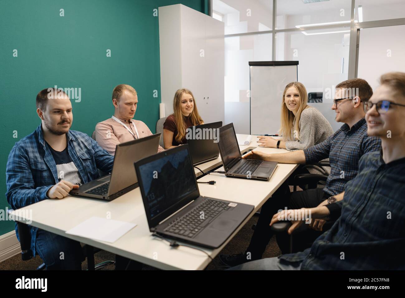 Group of young executives holding a work meeting in a conference room ...