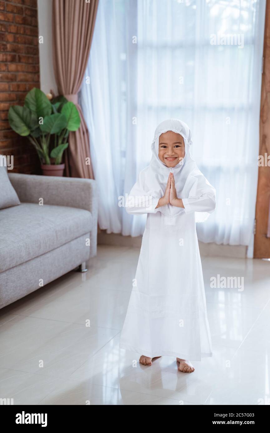 beautiful muslim toddler smiling with greeting gesture Stock Photo - Alamy