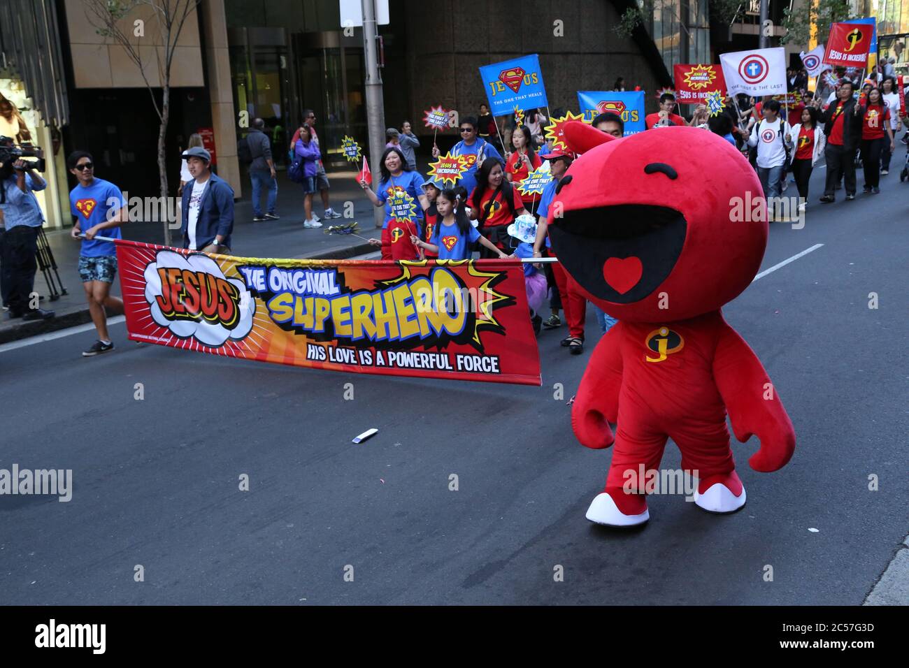 Christians taking part in the Sydney Easter Parade hold a banner saying ...