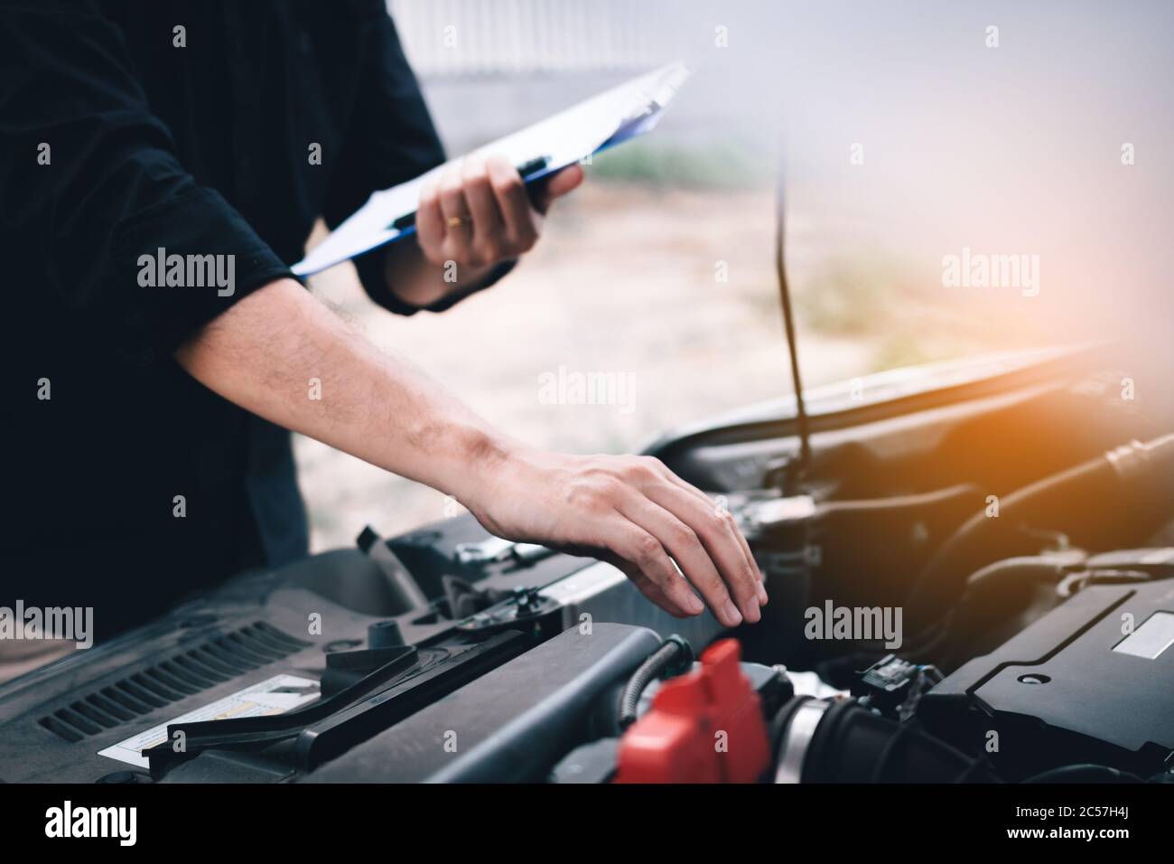 Car mechanic repairing vehicle engine working job Stock Photo - Alamy
