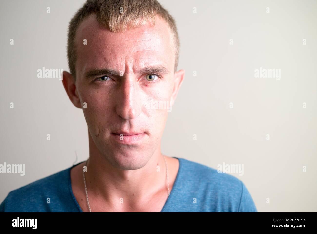 Face of stressed man with blond hair looking angry Stock Photo - Alamy