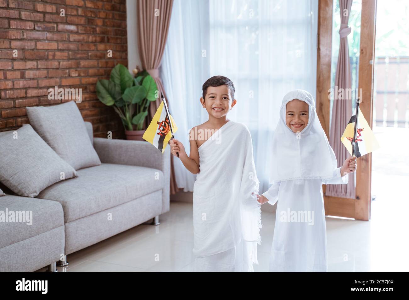 cute little kid wearing muslim ihram clothes and dress. hajj and umrah ...