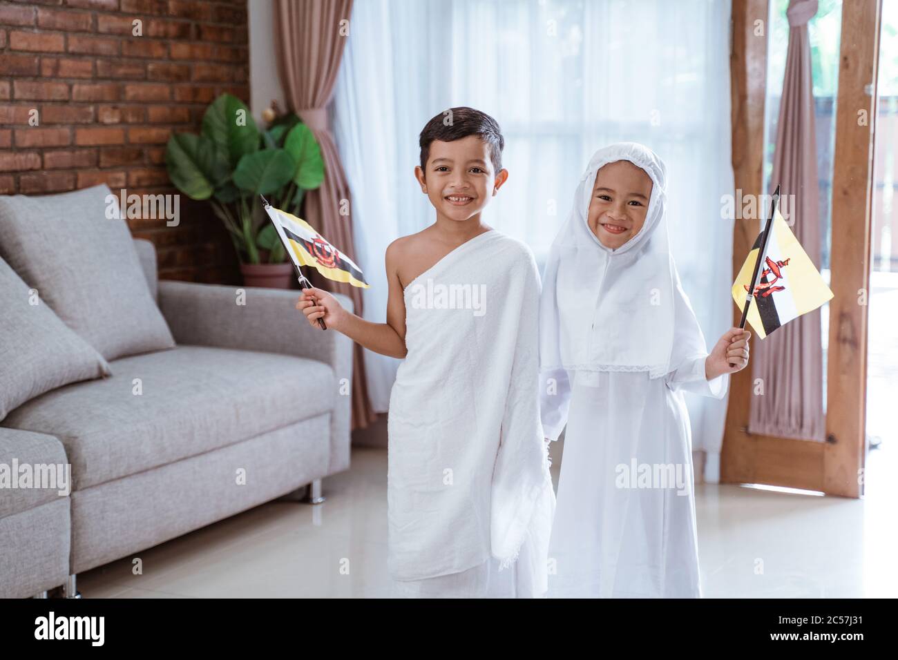 cute little kid wearing muslim ihram clothes and dress. hajj and umrah ...