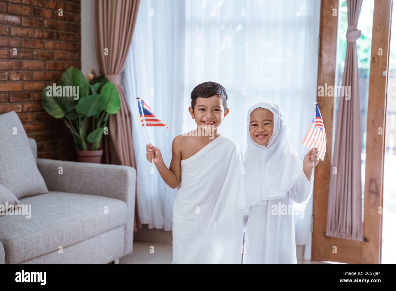 cute little kid wearing muslim ihram clothes and dress. hajj and umrah ...