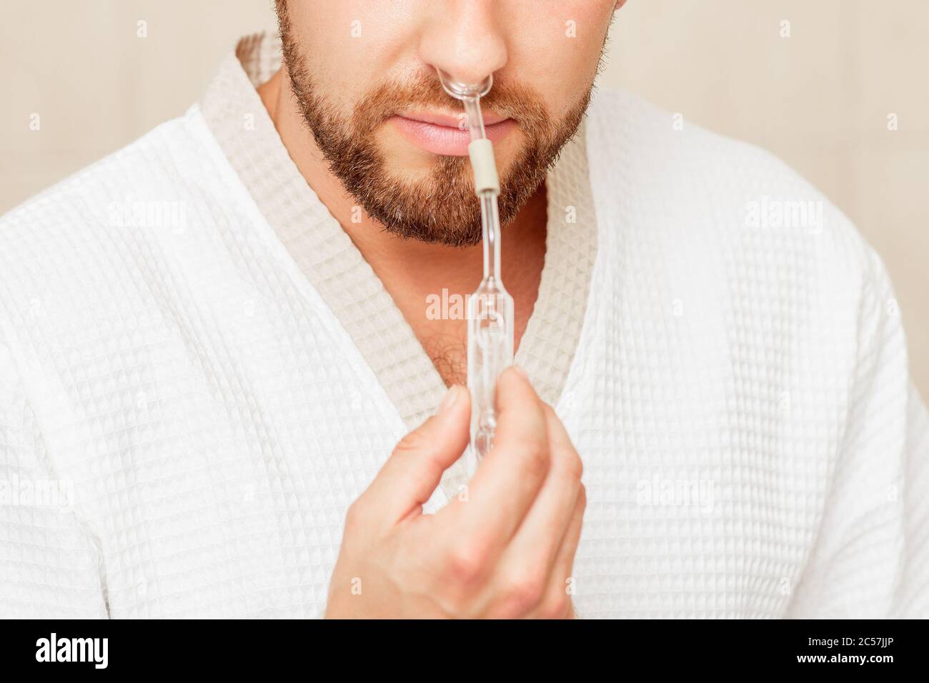 Man receives nasal inhalation Maholda by essential oil in nose at spa ...