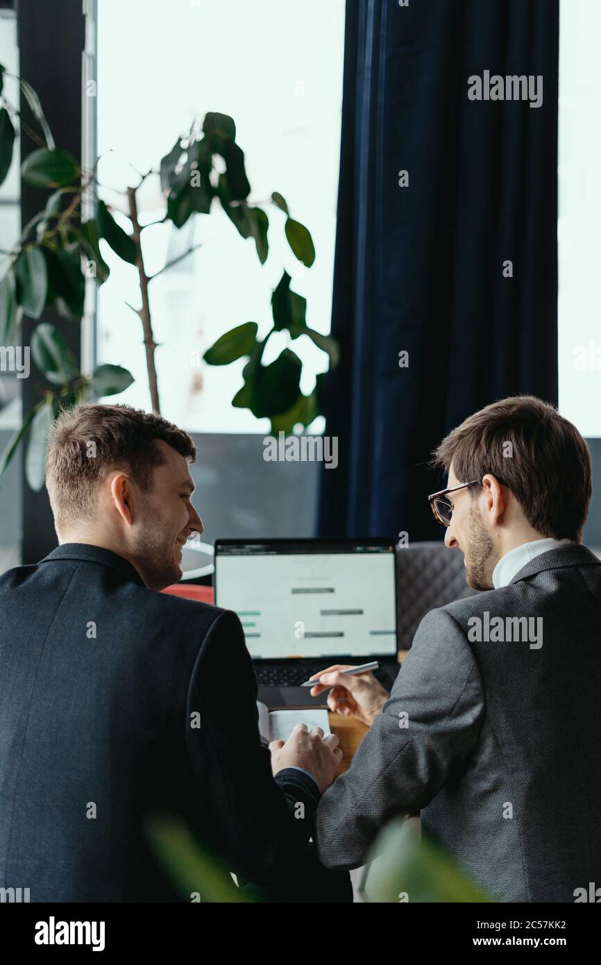 Back view businessman listening to business partner talking during ...