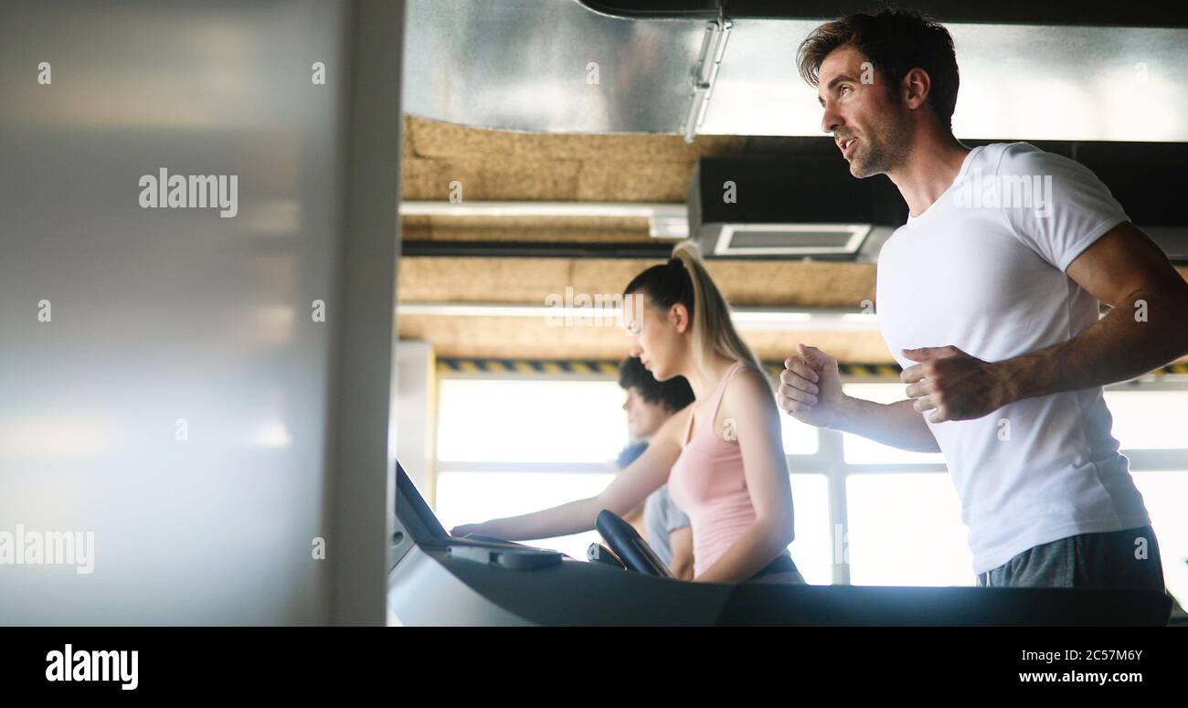 Group of fit healthy friends people cardio workout in gym Stock Photo ...