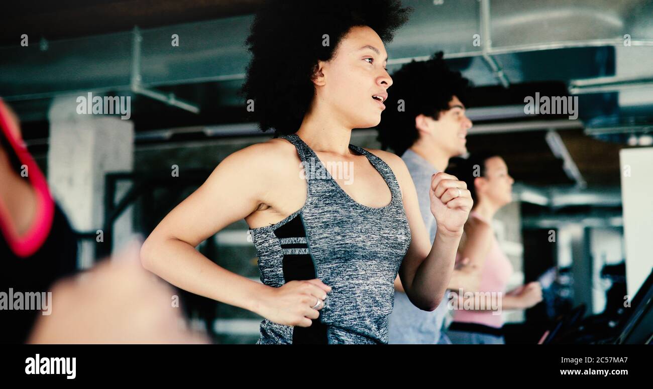 Group of fit healthy friends people cardio workout in gym Stock Photo ...