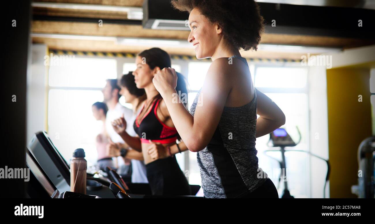 Group of fit healthy friends people cardio workout in gym Stock Photo ...