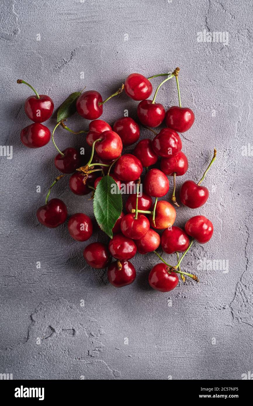 Fresh ripe cherry fruits with green leaves, summer vitamin berries on ...