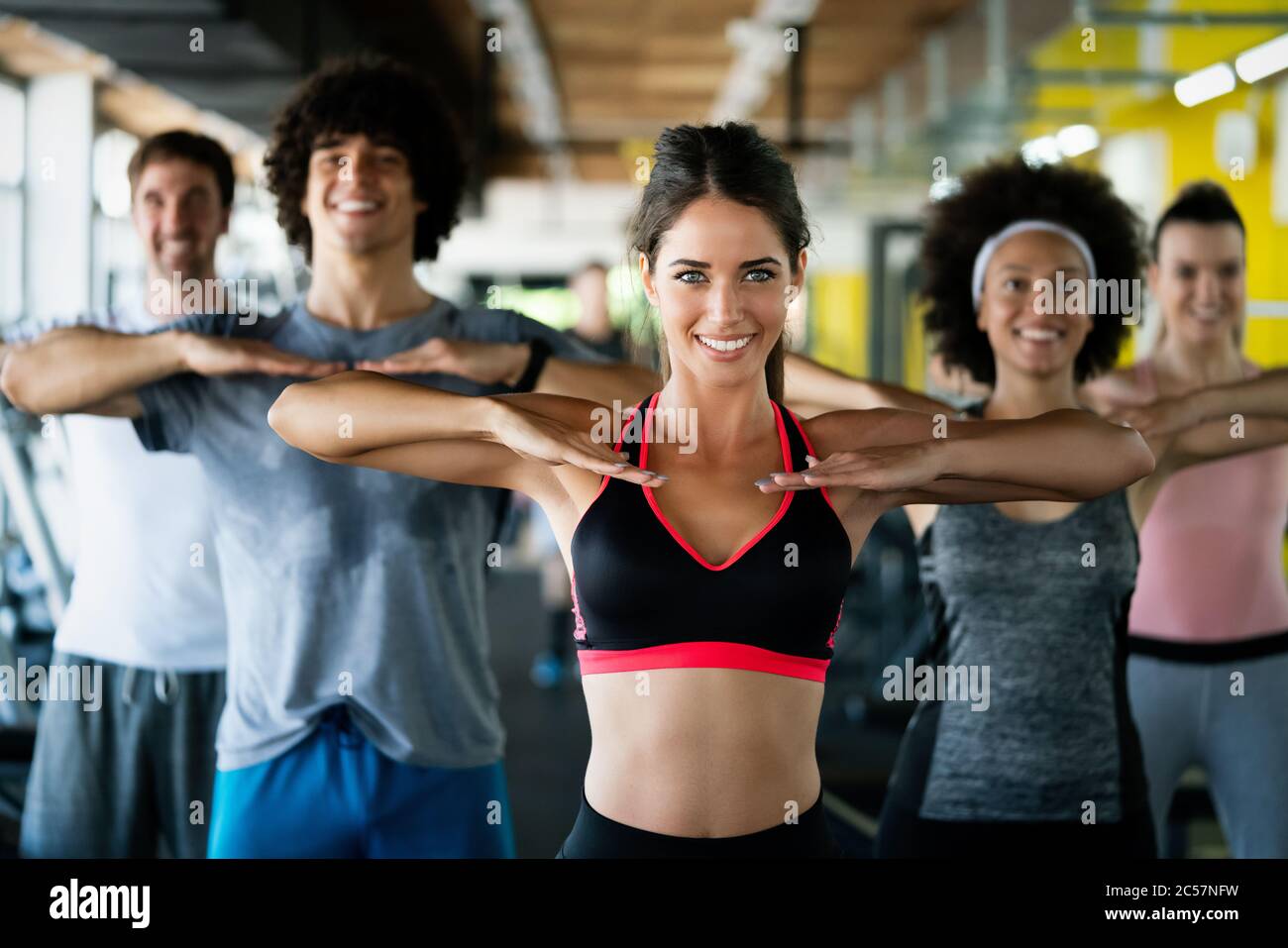 Group of happy multiracial friends exercising together in gym Stock ...