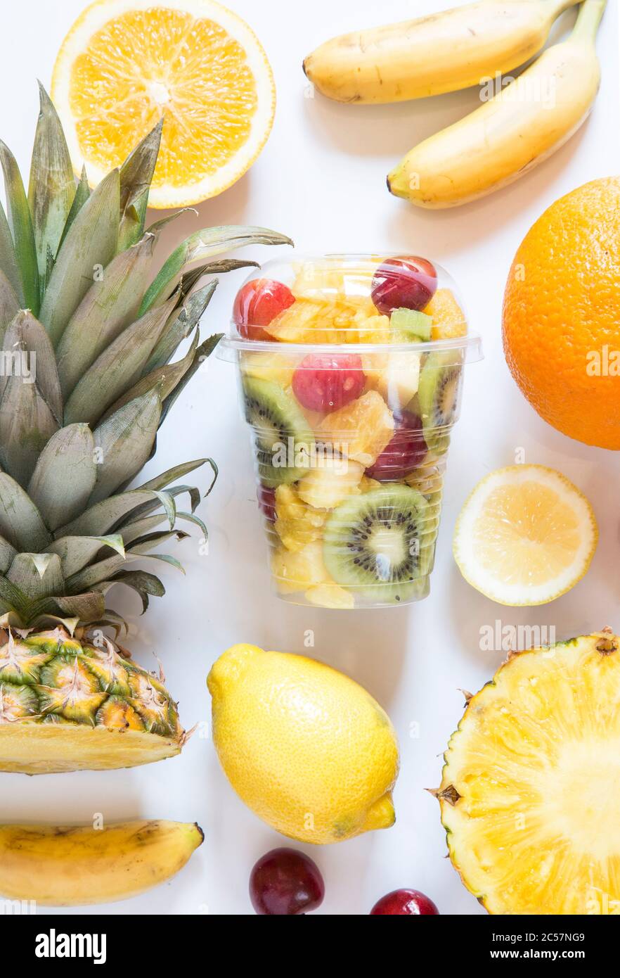 Tropical fruit cocktail in white background Stock Photo - Alamy