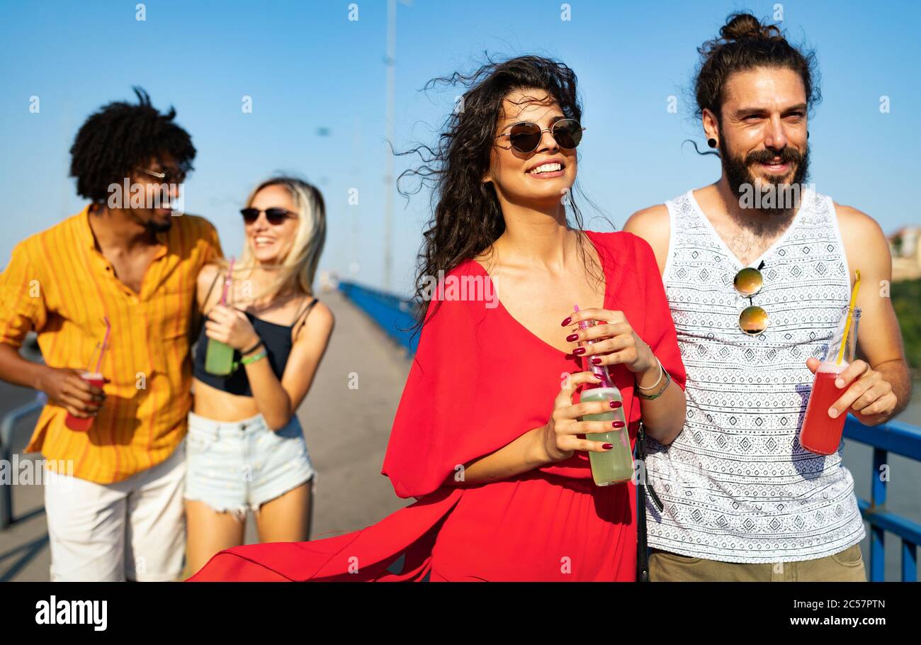 Group of friends having fun and hanging out outdoors Stock Photo - Alamy