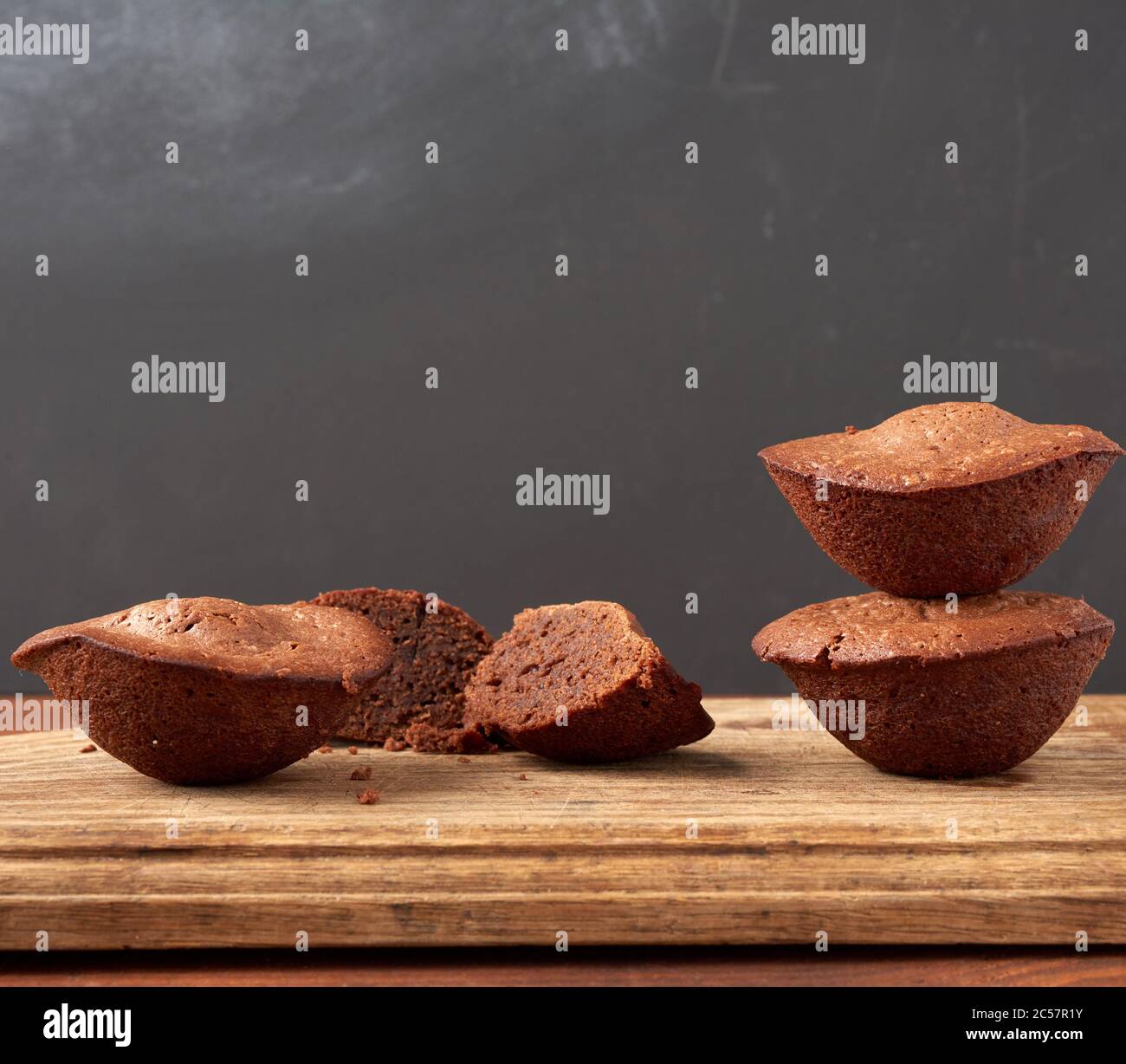 stack of baked brownie round cakes on a brown wooden board, copy space ...