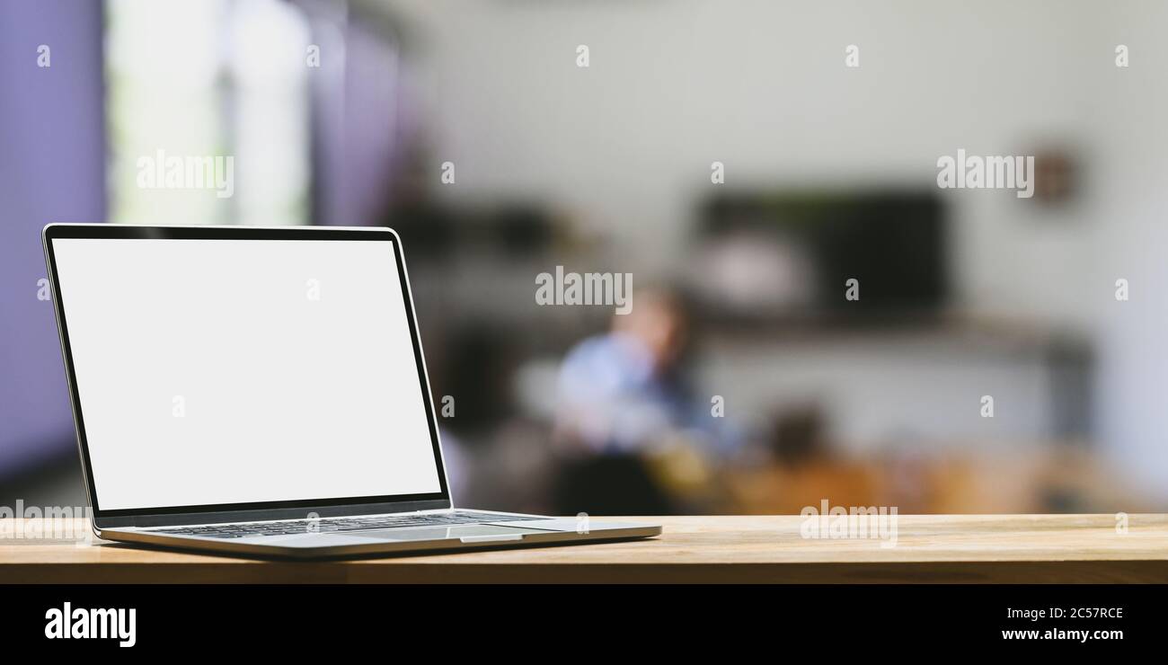 Computer laptop is putting on a wooden counter bar over the sitting ...