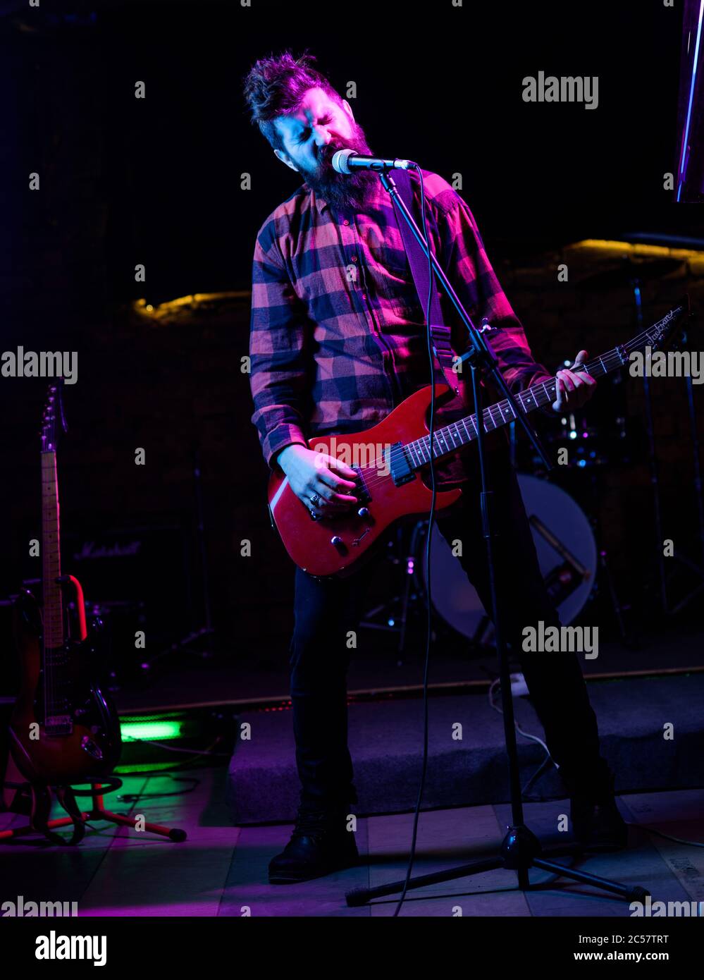 Frontman concept. Man with shouting face holds guitar, singing song ...