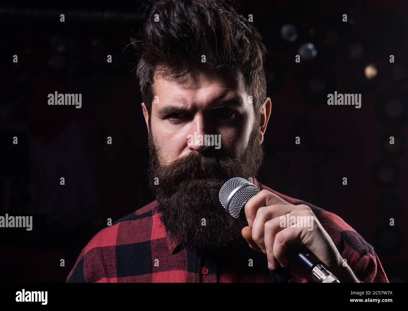 Vocalist concept. Man with tense face holds microphone, singing song ...