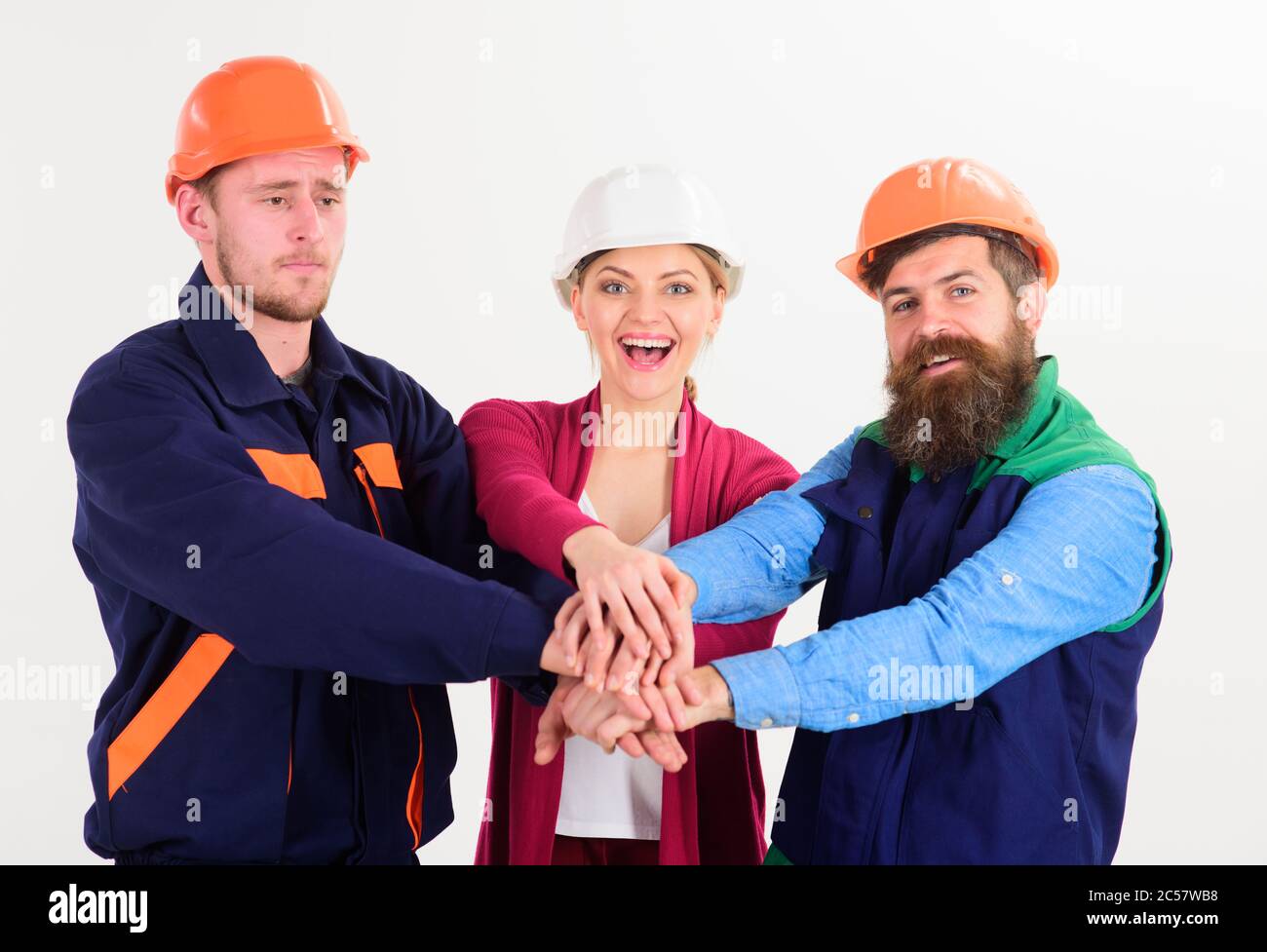 Woman and men in hard hats holds hands together. Builder, engineer ...