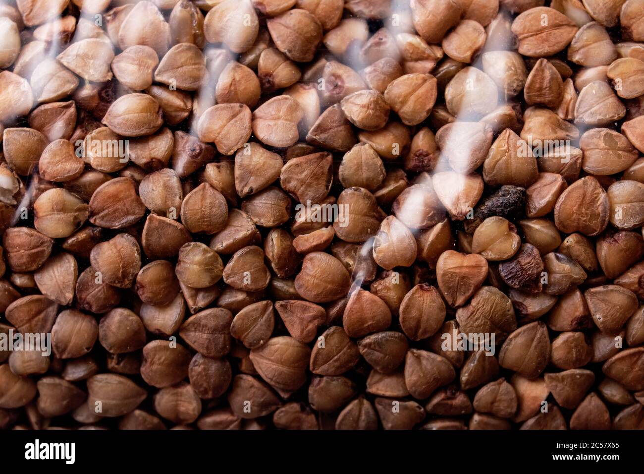 Brown buckwheat groats close up, background or texture Stock Photo - Alamy