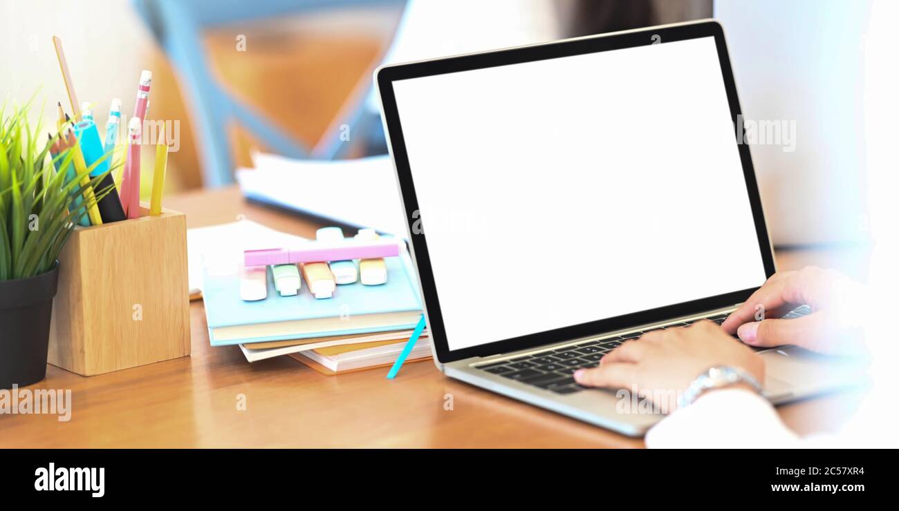 Behind shot of creative woman working on computer laptop with white ...