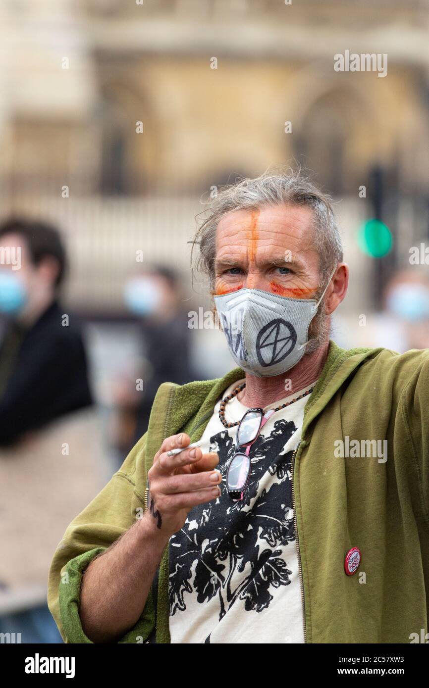 Portrait of a male protester with face mask and face paint, Black Lives ...