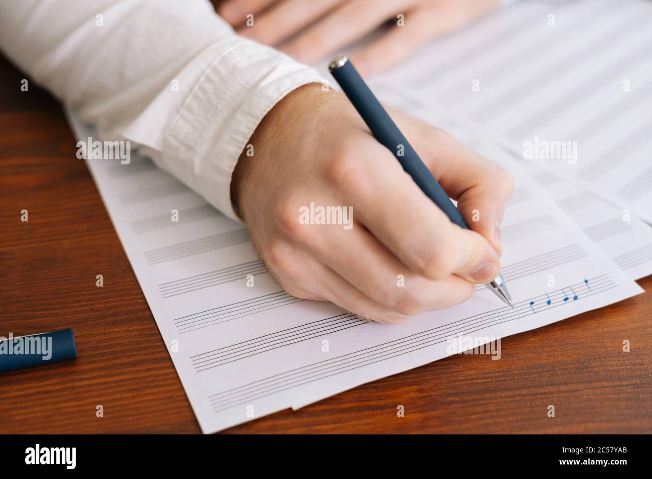 Hands writing on sheet music hi-res stock photography and images - Alamy