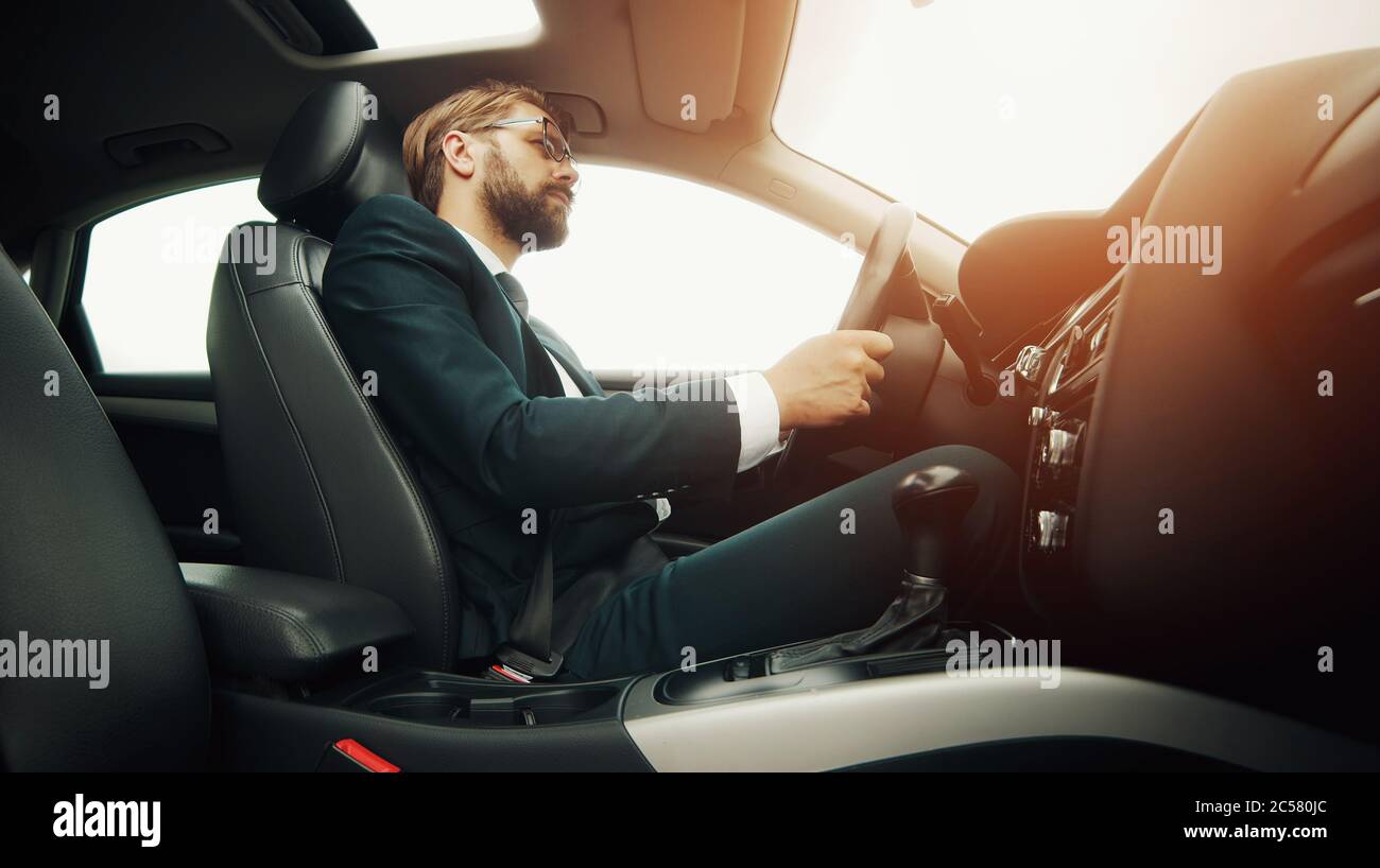 Elegant man driving car Stock Photo - Alamy