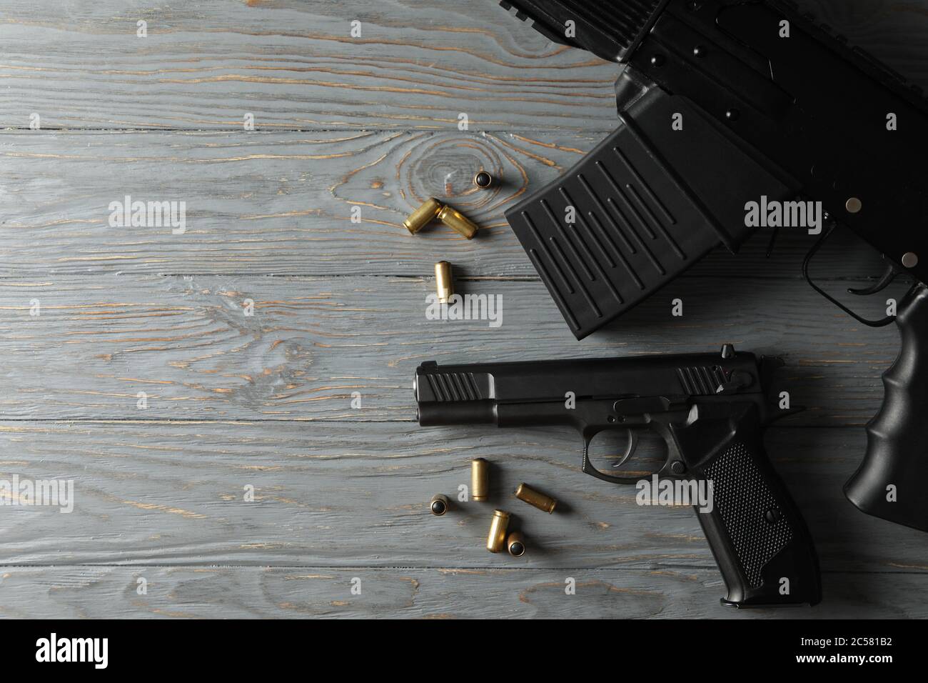 Weapon on gray wooden background, top view Stock Photo - Alamy