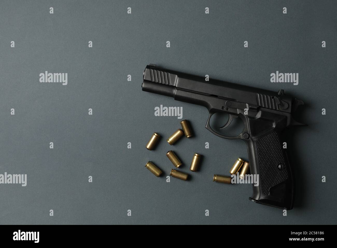 Pistol and traumatic bullets on dark gray background. Self defense ...