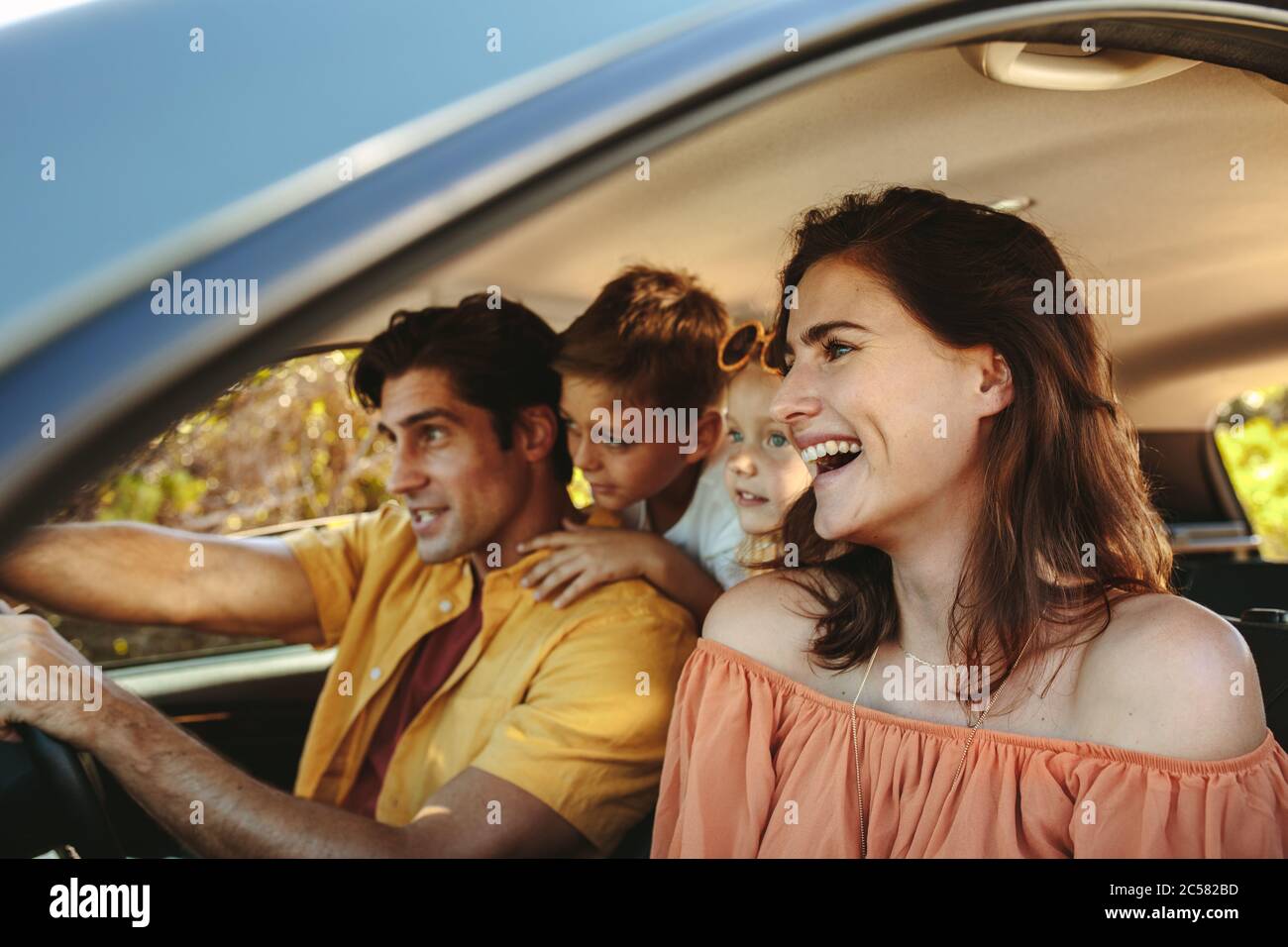 Father driving car with family. Happy family with two children driving ...