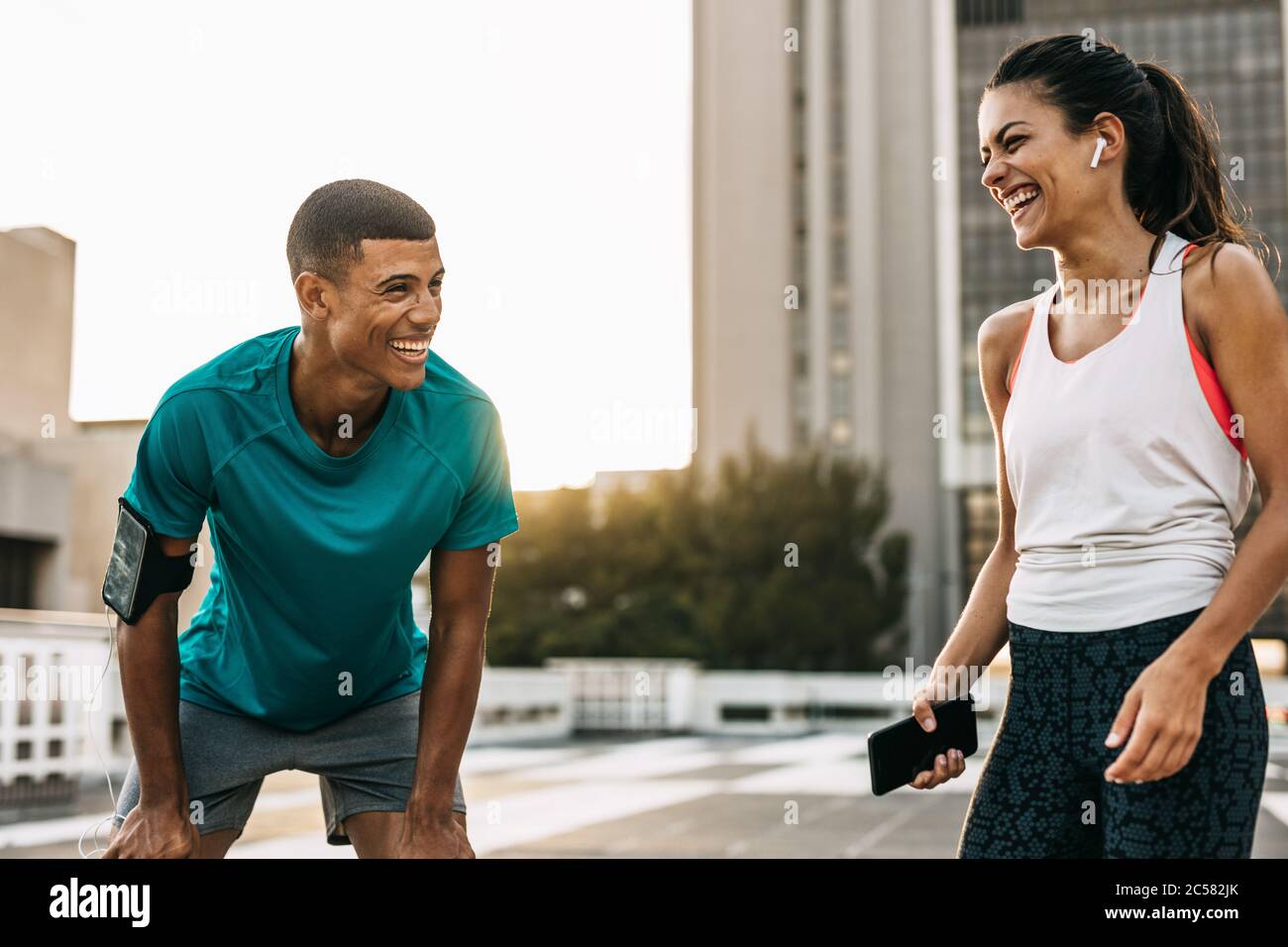 Two people taking a break after training session outdoors and smiling ...