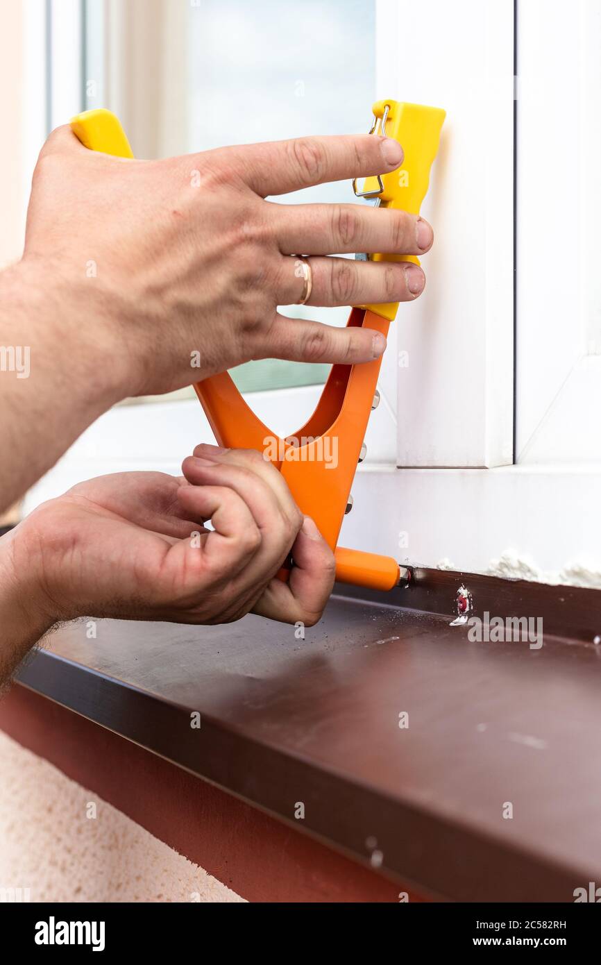 Construction work - installation of rivets. Window tint repair. Plastic ...