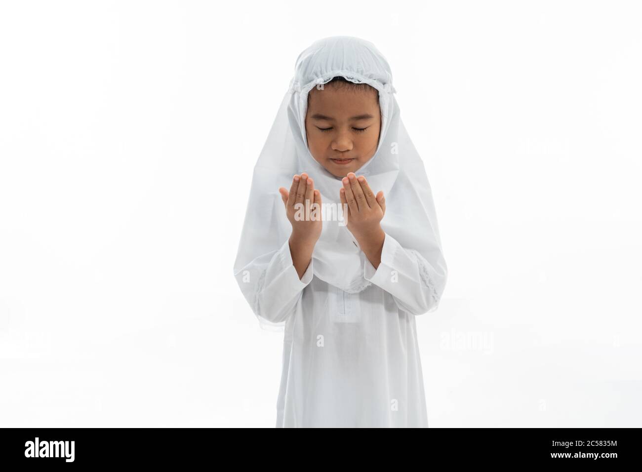 muslim kid praying isolated over white background Stock Photo - Alamy