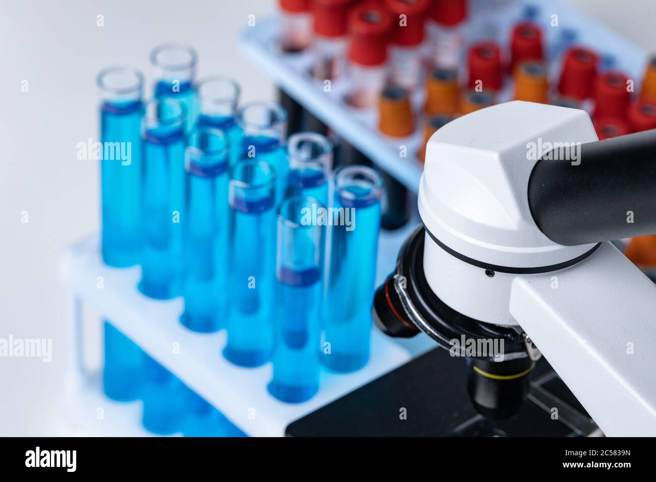 Microscope with test tubes for research close up Stock Photo - Alamy