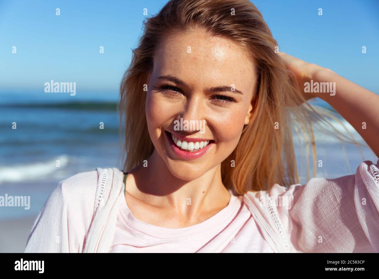 Portrait of woman smiling on the beach Stock Photo - Alamy