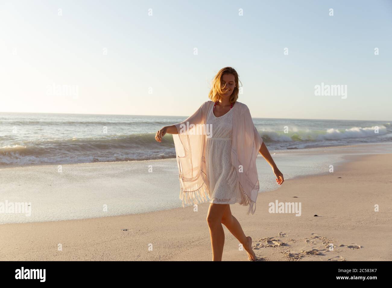 Beautiful woman walking on the beach Stock Photo - Alamy